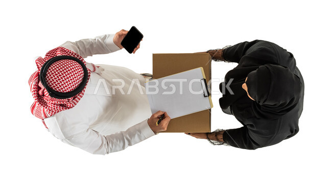 A Saudi Gulf man uses a mobile phone and signs and confirms receipt of ...