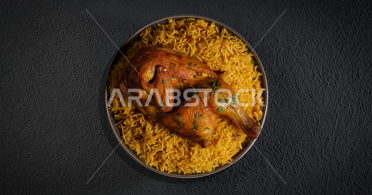 A dish of Kabsa rice with chicken, traditional Arabic food, popular ...