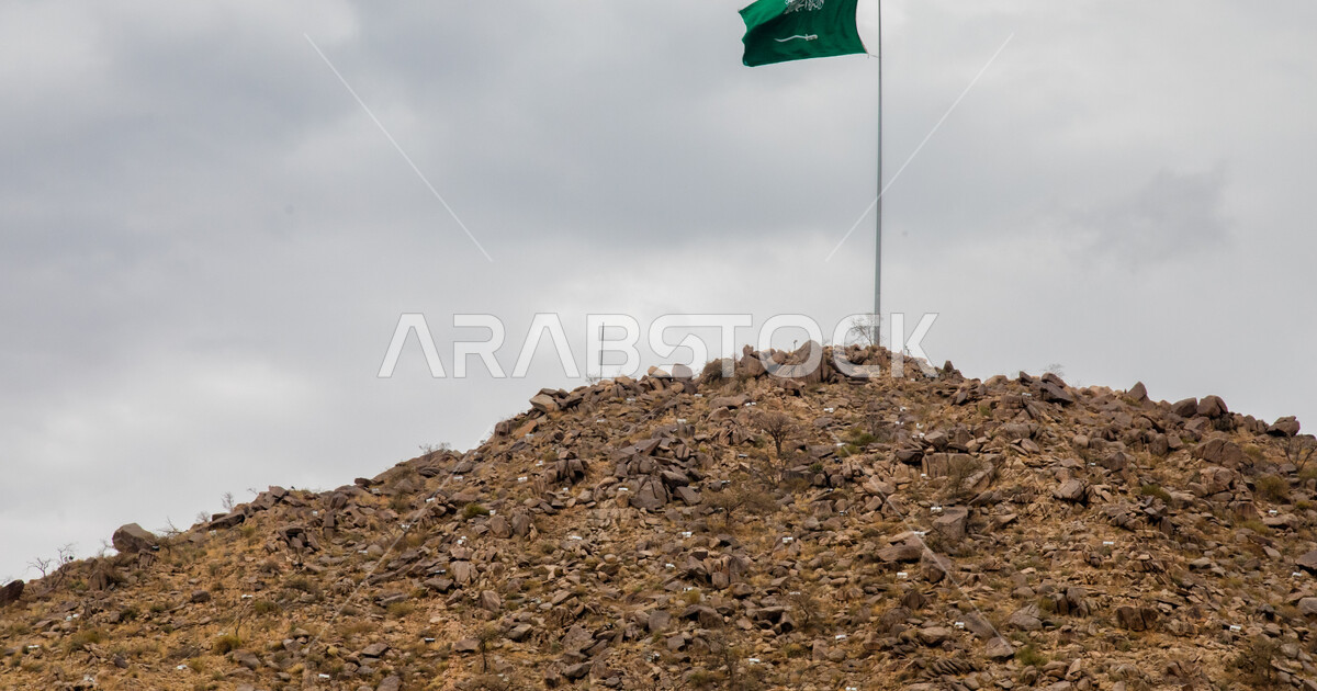 The flag of Saudi Arabia flutters on the top of the Asir Mountains, the ...