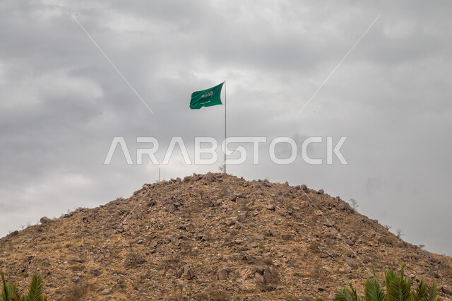 The flag of Saudi Arabia flutters on the top of the Asir Mountains, the ...