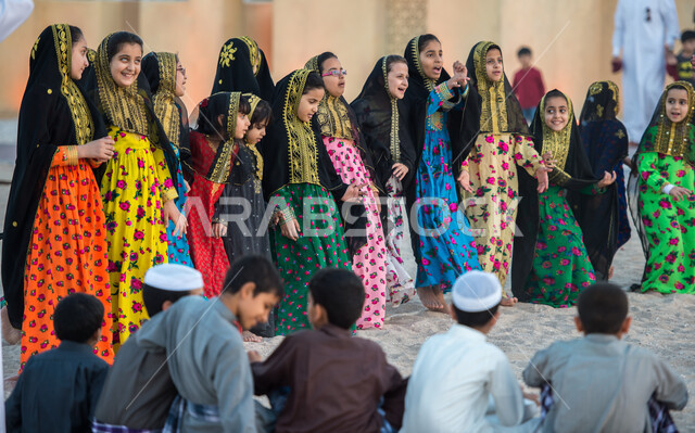 A group of Qatari Gulf Arab children in Qatari Gulf costume, playing ...