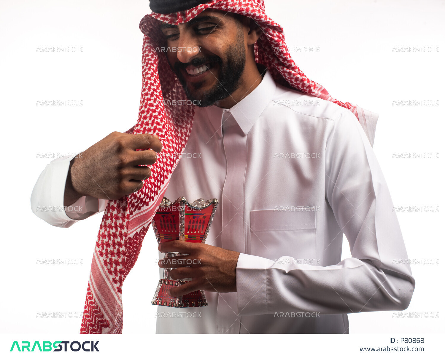 Portrait of a Saudi Arabian man holding an incense holder in his hand ...