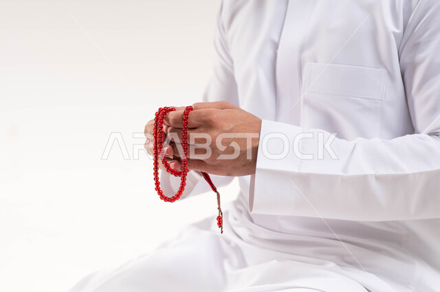 A close-up of a Saudi Arabian Gulf man, in his hand the rosary, praise ...
