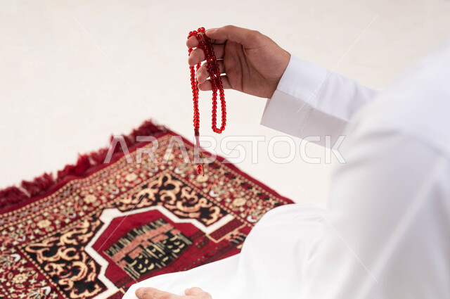 A close-up of a Saudi Arabian Gulf man, in his hand the rosary, praise ...