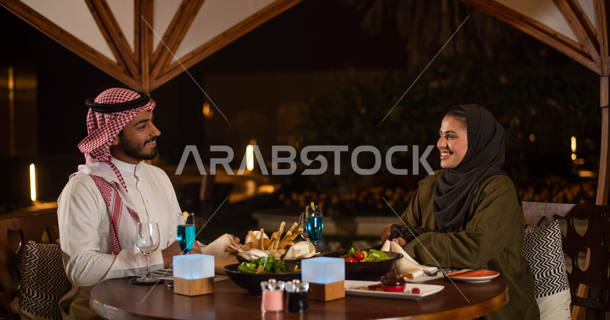 A Saudi Arab Gulf couple enjoying an exchange of conversation in a ...