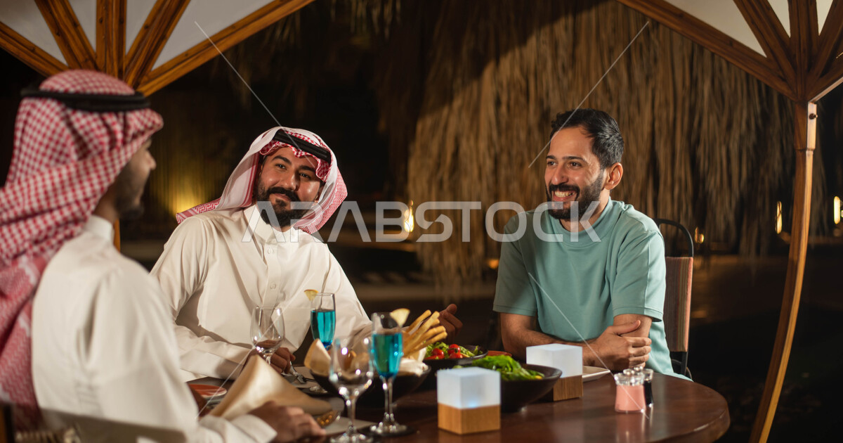 Saudi Gulf Arab youth enjoying an exchange of conversation in a Saudi ...