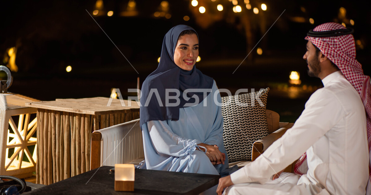 A Saudi Arabian Gulf couple enjoying an exchange of conversation in one ...