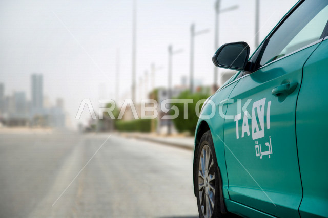 Green taxi in the streets of Saudi Arabia, taxi with modern tracking ...