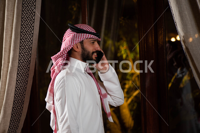 A Saudi Gulf Arab man making a phone call, communicating with ...