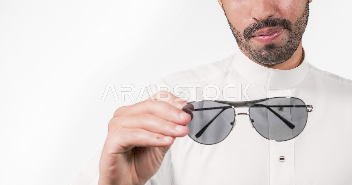 Portrait of a young Saudi Arabian Gulf youth wearing traditional Saudi ...