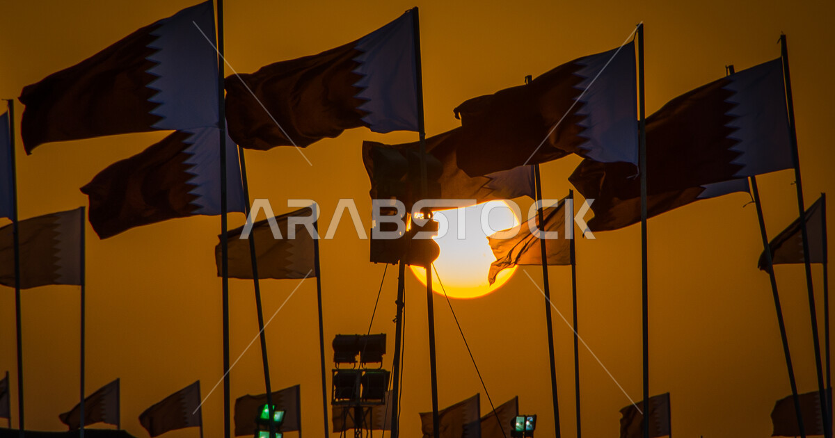 Flags of the State of Qatar, the Qatari national flag flying high, the ...