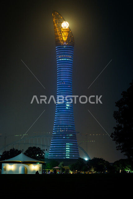 The Torch Tower in the Sports City in Doha, Qatar, at night, a glowing ...