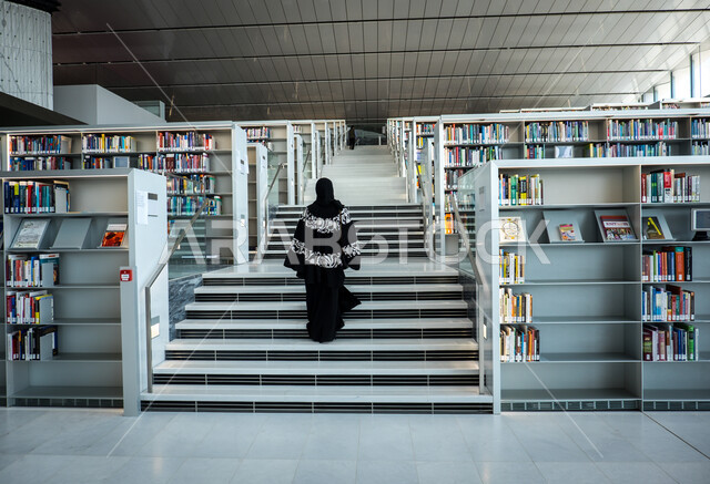 A picture from the back of an Arab Gulf Qatari woman wandering in a ...