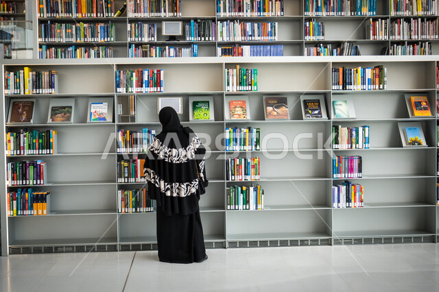 A picture from the back of an Arab Gulf Qatari woman standing inside a ...