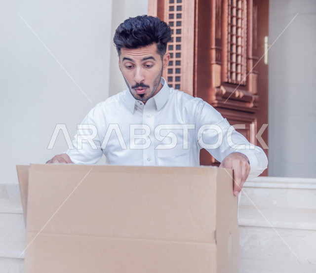 A young Saudi Arabian Gulf man opens the order, face and hands gestures ...