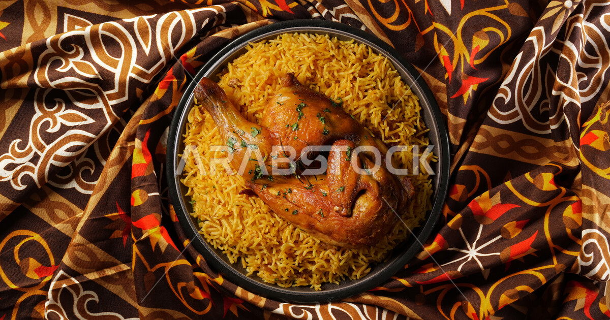 A dish of Kabsa rice with chicken and vegetables, traditional Gulf Arab ...