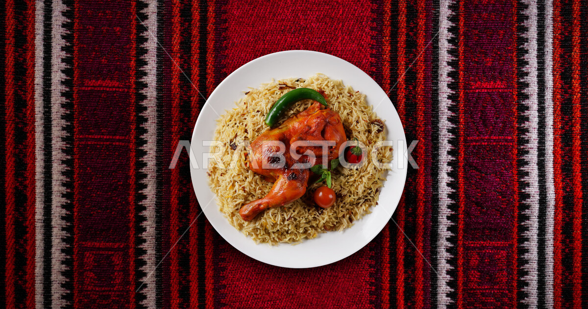 A dish of Kabsa rice with chicken and vegetables, traditional Gulf Arab ...