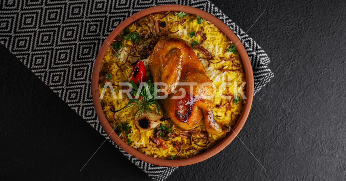 A dish of Kabsa rice with chicken and vegetables, traditional Gulf Arab ...