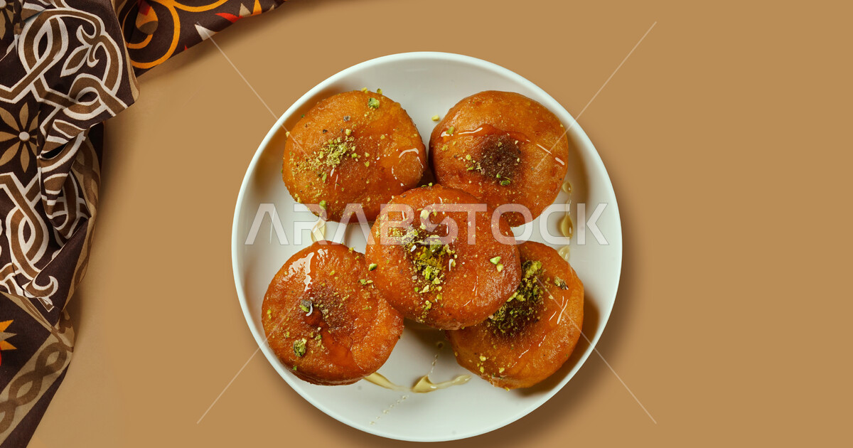 A dish of sweet luqaimat, sweets and sugars, dessert dumplings ...