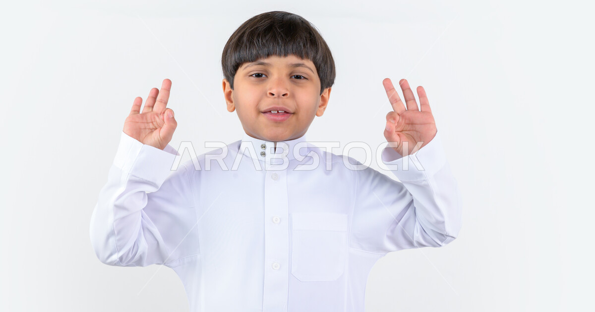 Portrait of a Saudi Arabian Gulf child wearing the Saudi thobe, facial ...