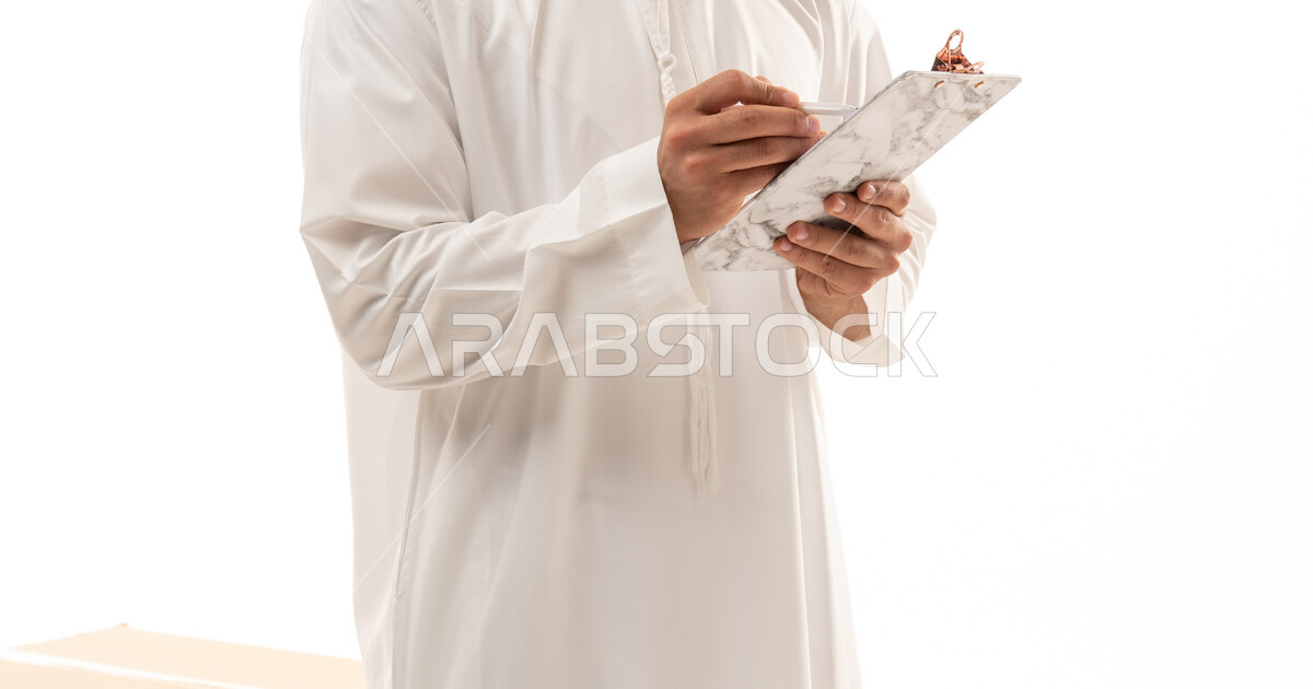 Portrait of an Arab Emirati Gulf man wearing Emirati dress, working in ...