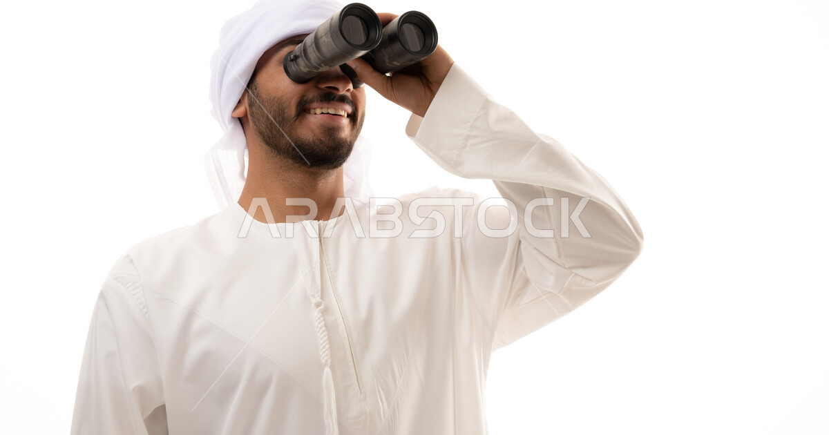 Portrait of an Arab Emirati Gulf man in traditional attire holding ...