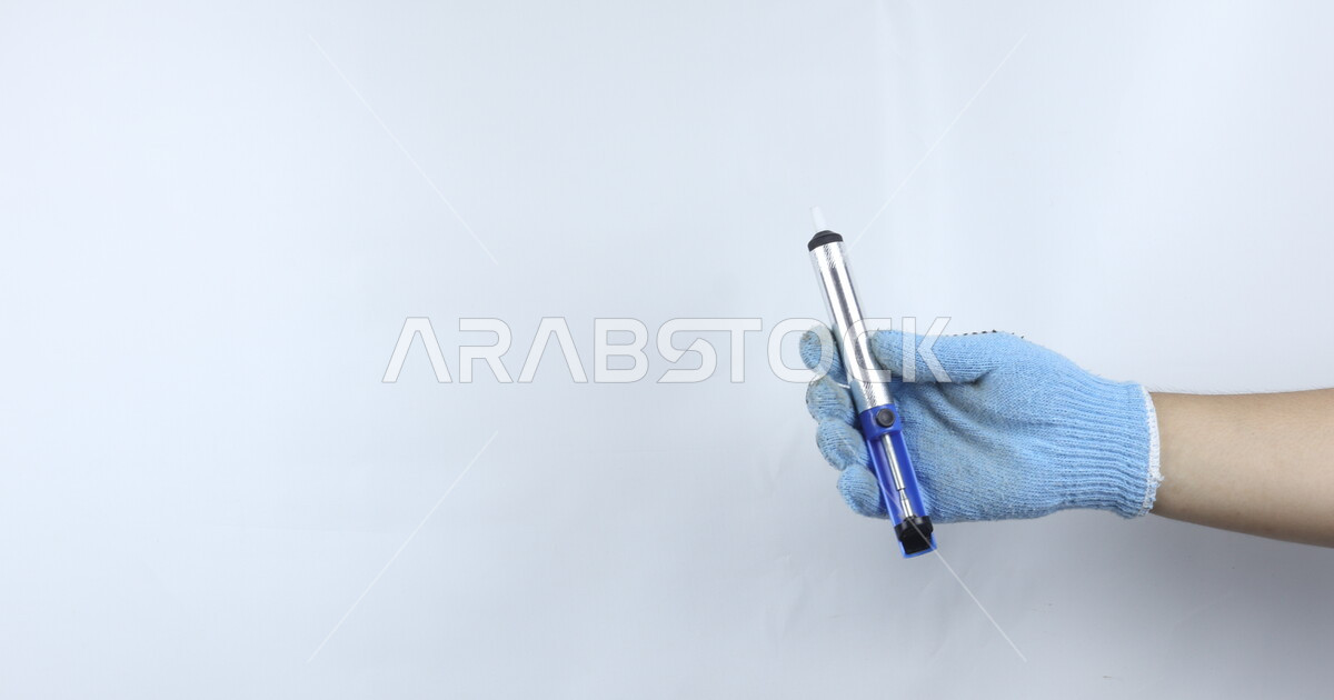 Close-up of a gloved hand holding a covered marker, note plan, marking ...