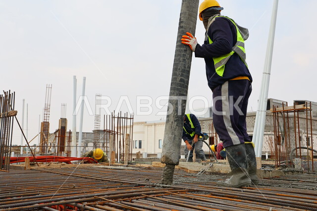 Construction workers doing roofing work, construction equipment and ...