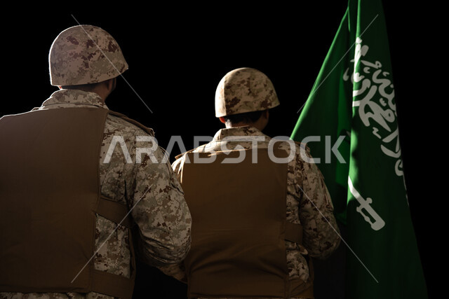 Portrait from the back of two Saudi Arabian Gulf soldiers wearing ...