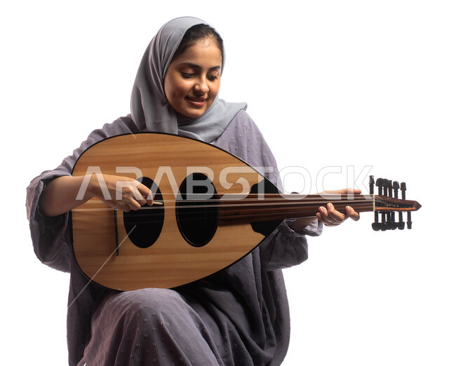 Portrait of a Saudi Arab Gulf woman playing the Oud instrument ...