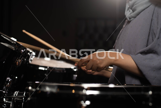 Practicing the hobby of drumming on an electronic drum machine, using ...