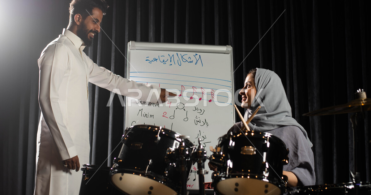 A Saudi Arabian Gulf man gives training sessions, a woman learns to ...