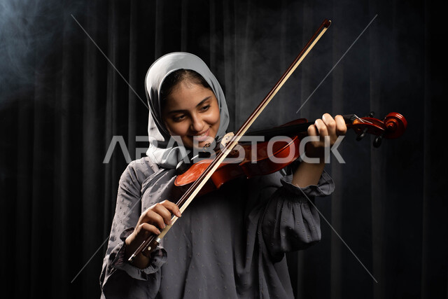 A Saudi Gulf Arab musician, an artist who plays the violin, musical ...