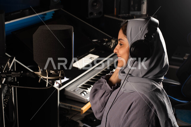 A Saudi Arabian Gulf woman, an artist in the audio recording studio, musical artistic talents ...