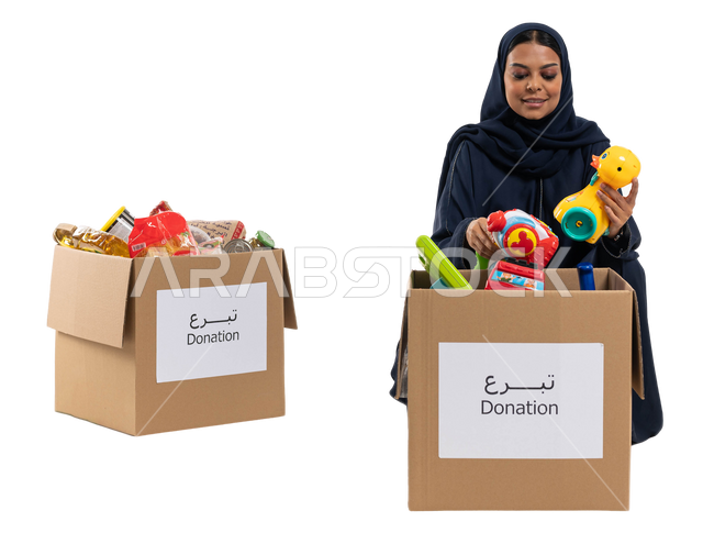 Portrait of a Saudi Arabian Gulf woman preparing a donation box full of ...