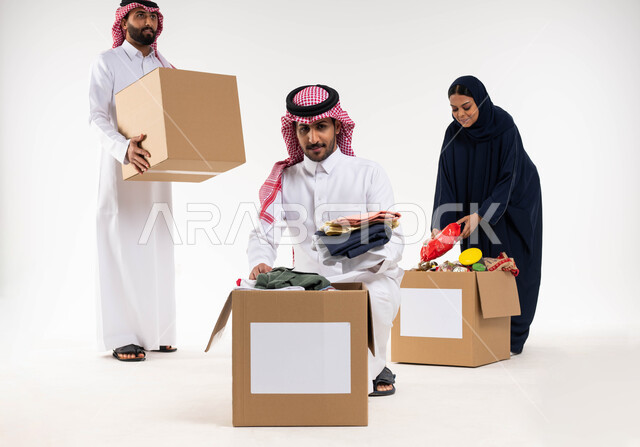 Arrangement of Eid clothes and gifts, a portrait of a group of Saudi ...