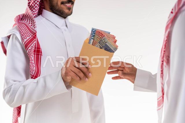 A close-up portrait of a Saudi Arab Gulf man in traditional Saudi dress ...