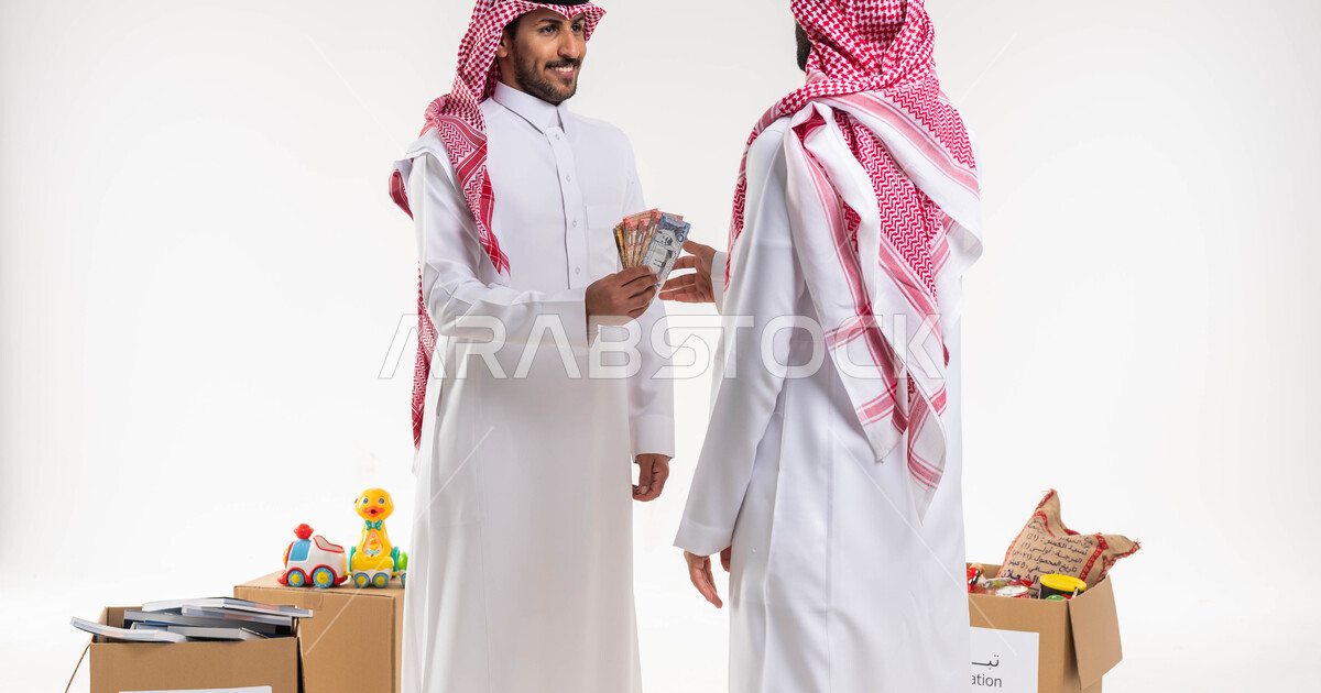 Portrait of a Saudi Arab Gulf man giving an envelope of paper money to ...