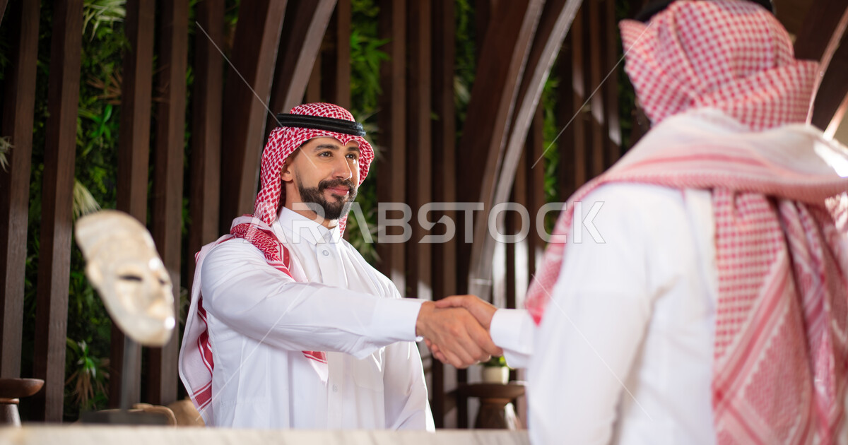 Two Saudi Arabian Gulf men wearing the traditional Saudi dress, a ...