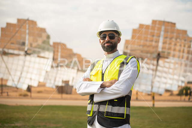Arab Gulf Saudi engineer, wearing a helmet and a protective vest ...