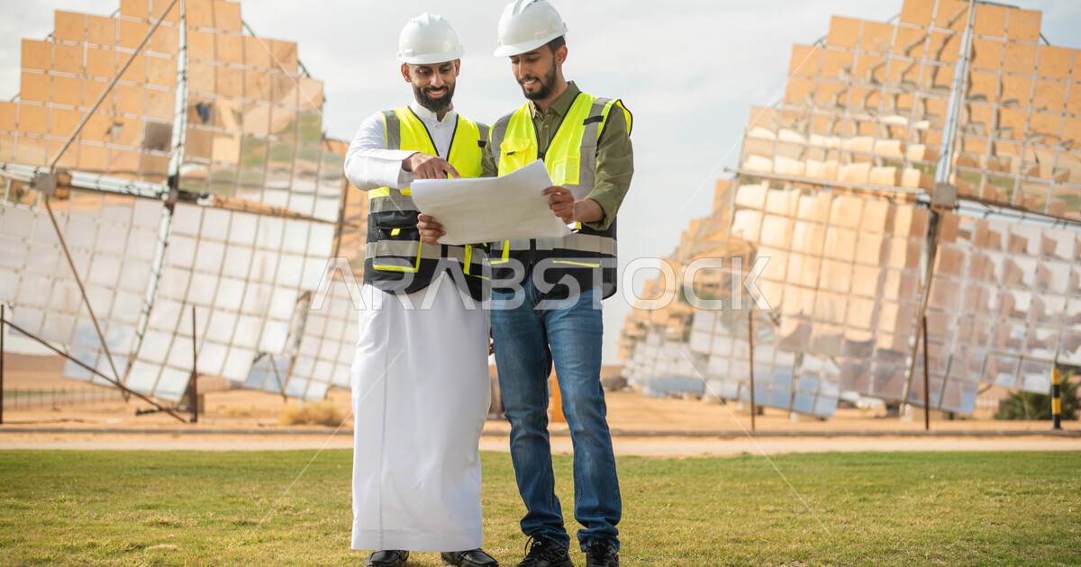 A back image of two Saudi Arab Gulf engineers supervising solar power ...