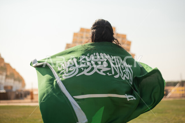 A picture from the back of a girl putting the flag of the Kingdom of ...