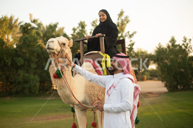 Camel riding events, a Saudi Arabian Gulf woman with her husband in a ...