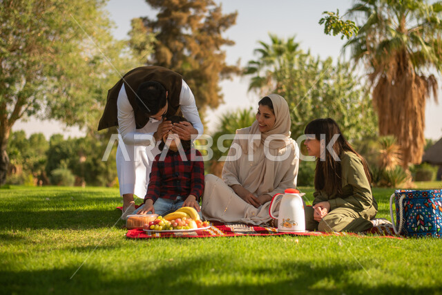 A picnic in the open air with the family, a Saudi Gulf Arab family ...