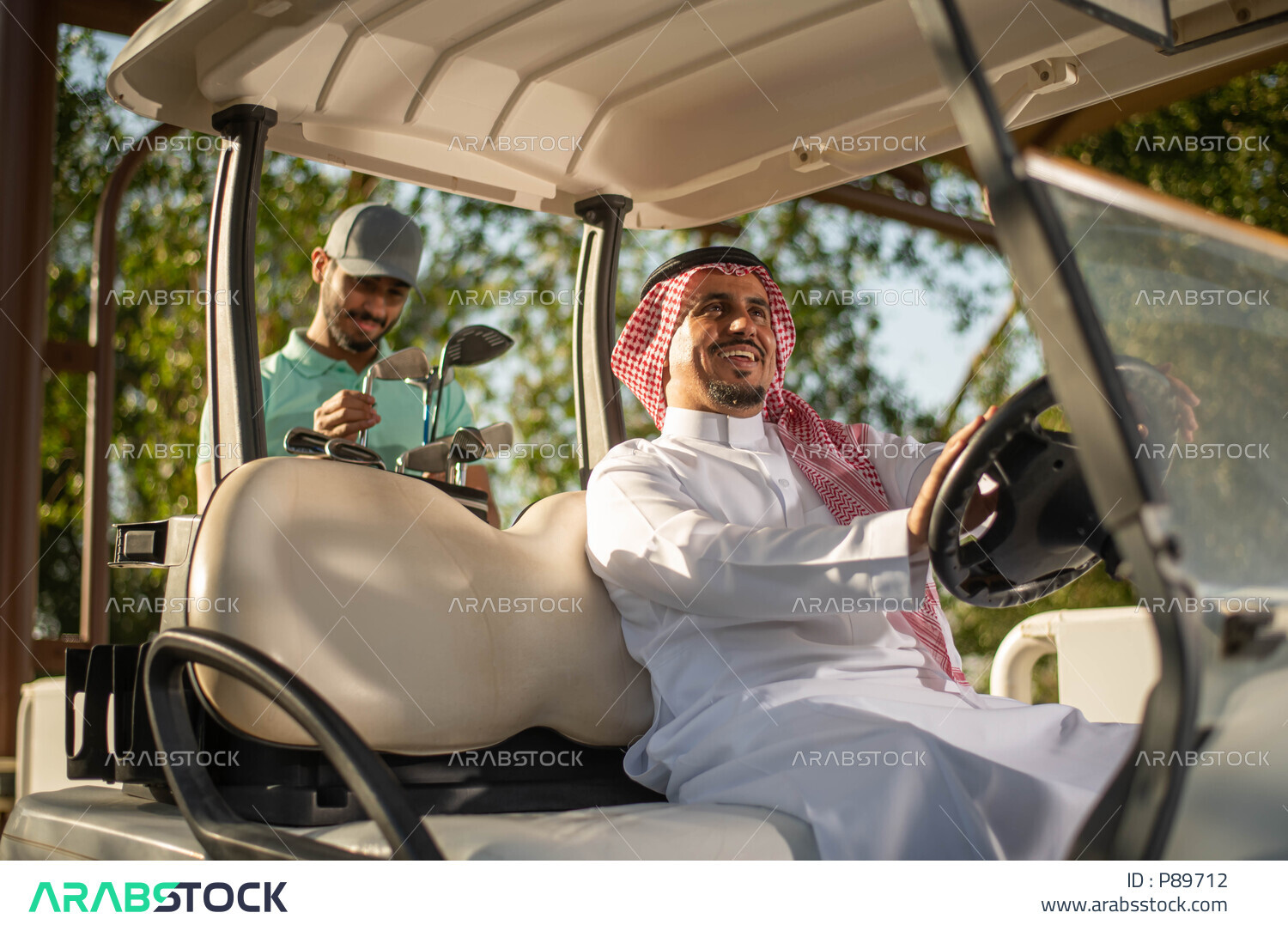Playing golf on large green areas, two Saudi Arabian Gulf men on the ...