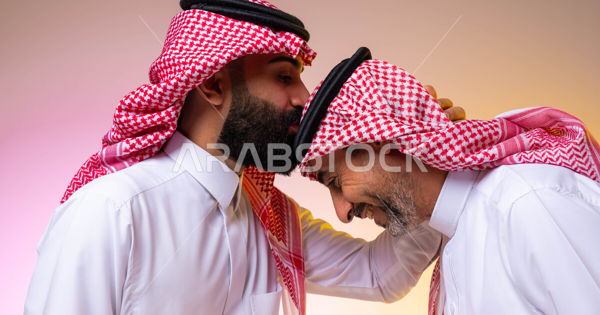Portrait of a Saudi Arab Gulf man kissing his father's head, gestures ...