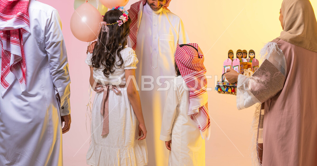 Portrait of a Saudi Arabian Gulf family celebrating the days of Eid, a ...