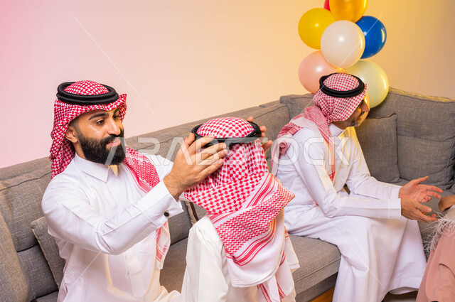 Portrait of a Saudi Arabian Gulf father wearing the traditional Saudi ...