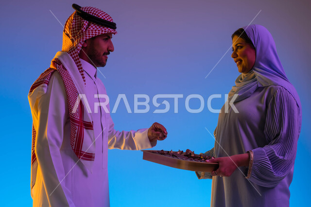 A Saudi Arab Gulf woman who provides Eid hospitality, honoring the ...