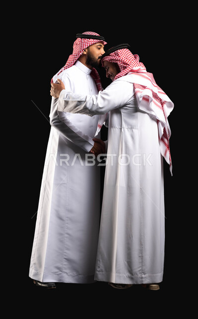 Two Saudi Arabian Gulf men dressed in traditional Saudi dress, facial ...